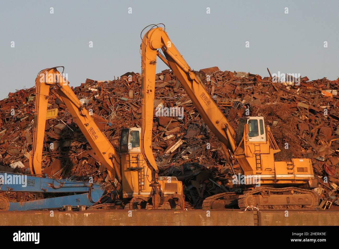 Two excavators at a scrap yard in the harbour, Hamburg, Germany Stock ...