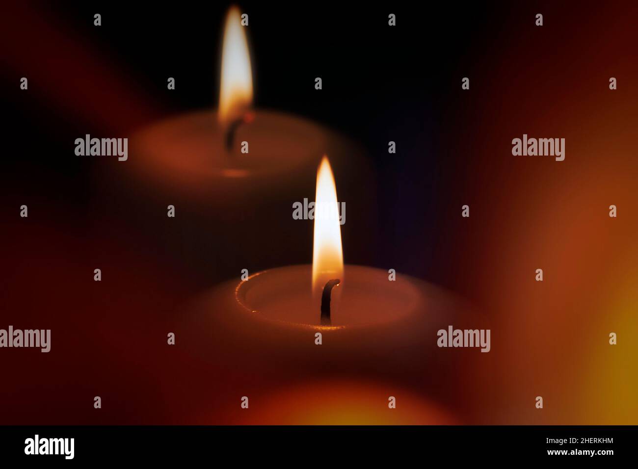 Two candles burning, warm atmospheric light, symbol of hope Stock Photo ...