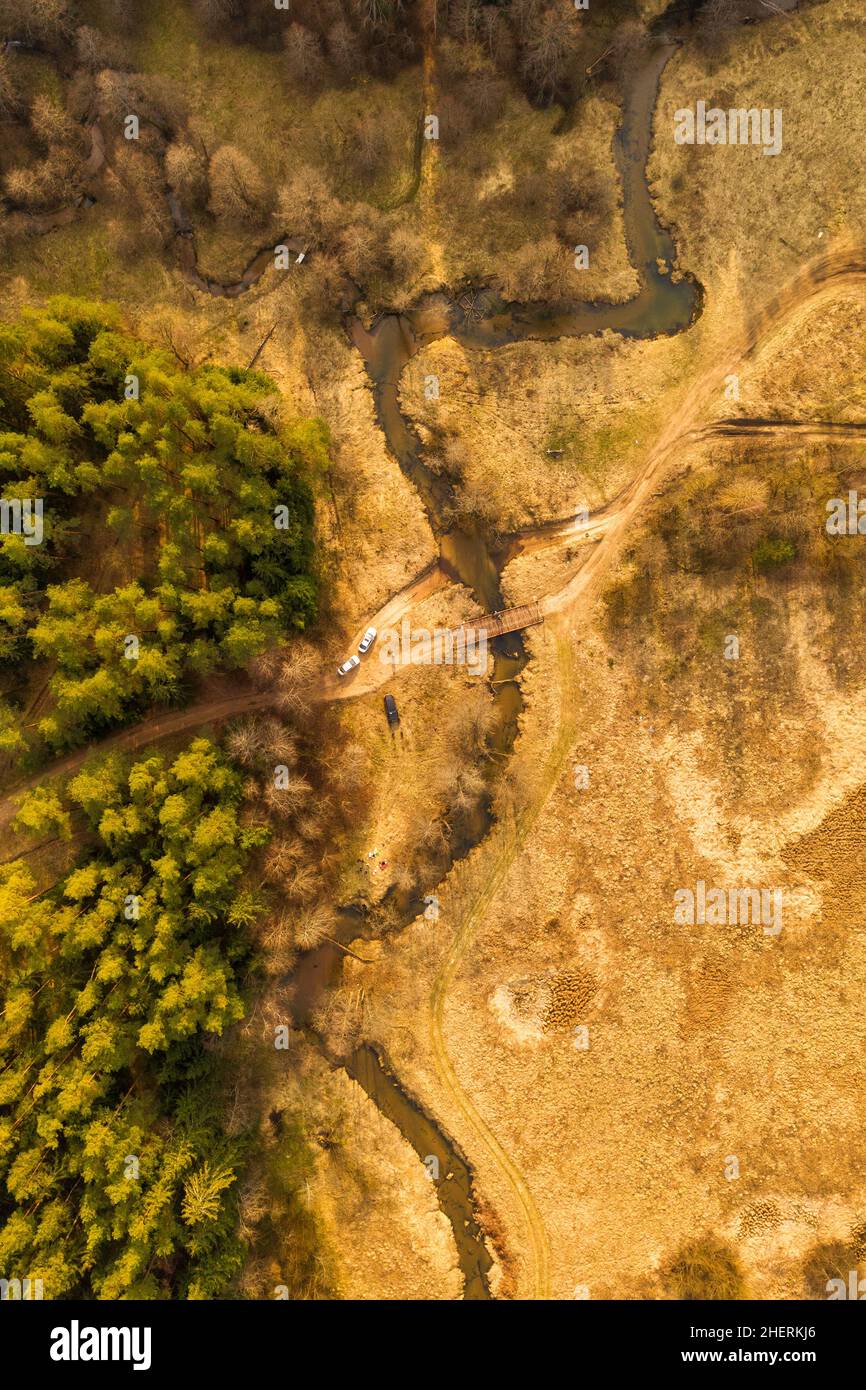Aerial of winding stream from above. Small river flowing through rural ...