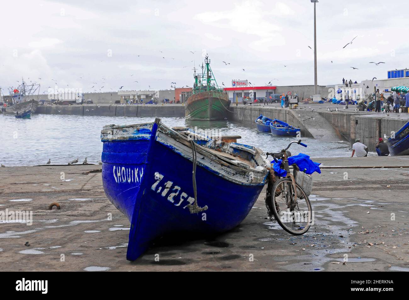 Blue fishing boat with bicycle, in the harbour of Essaouira, Morocco ...