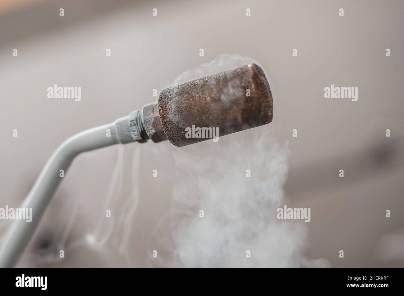 Smoking frozen pipe for liquid nitrogen. Close-up Stock Photo - Alamy