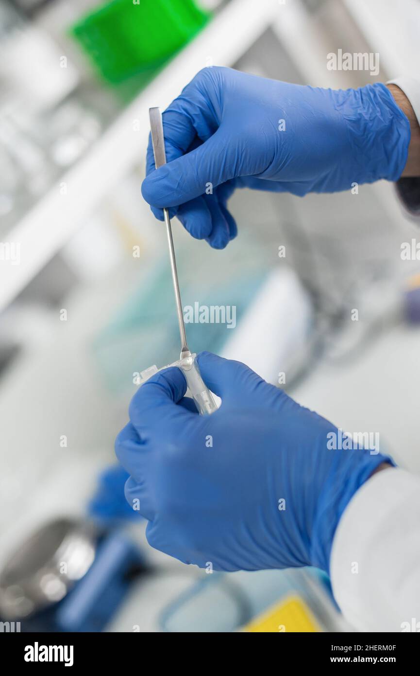 Laboratory technician take a sample for testing with chemistry spoon in ...