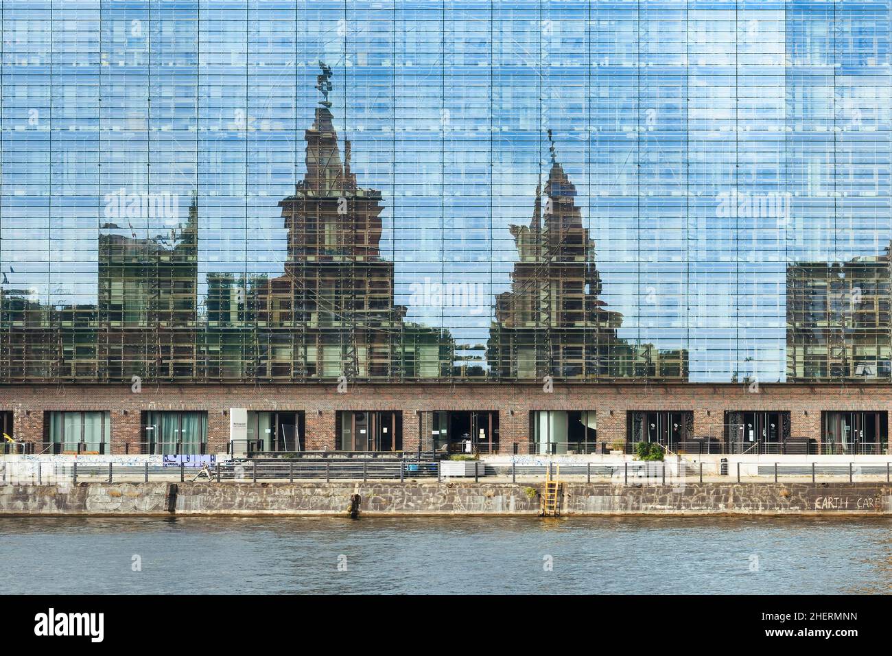 Reflection on a glass window building, Spree river, Berlin, Germany ...