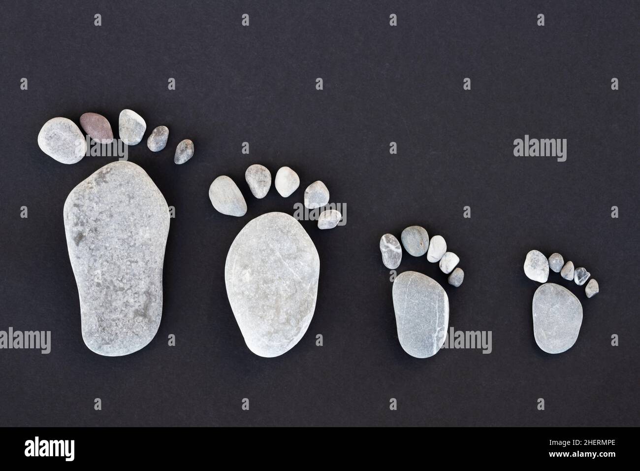 Symbolic lime stones forming stone foots of parents and two kids with ...