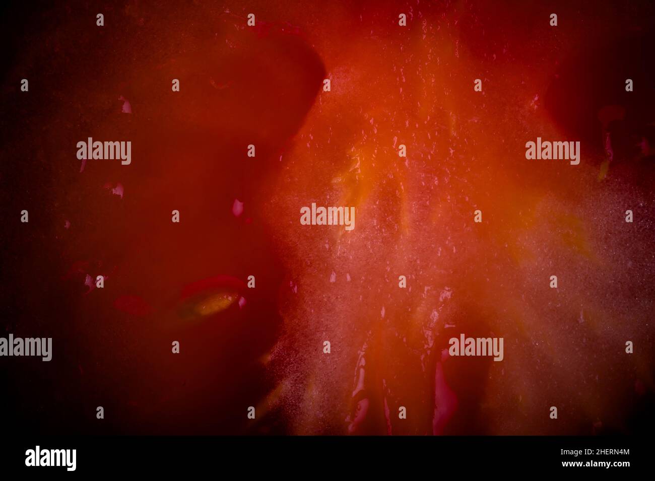 Abstract and art tomato slice detail. Macro shooting. Red background ...