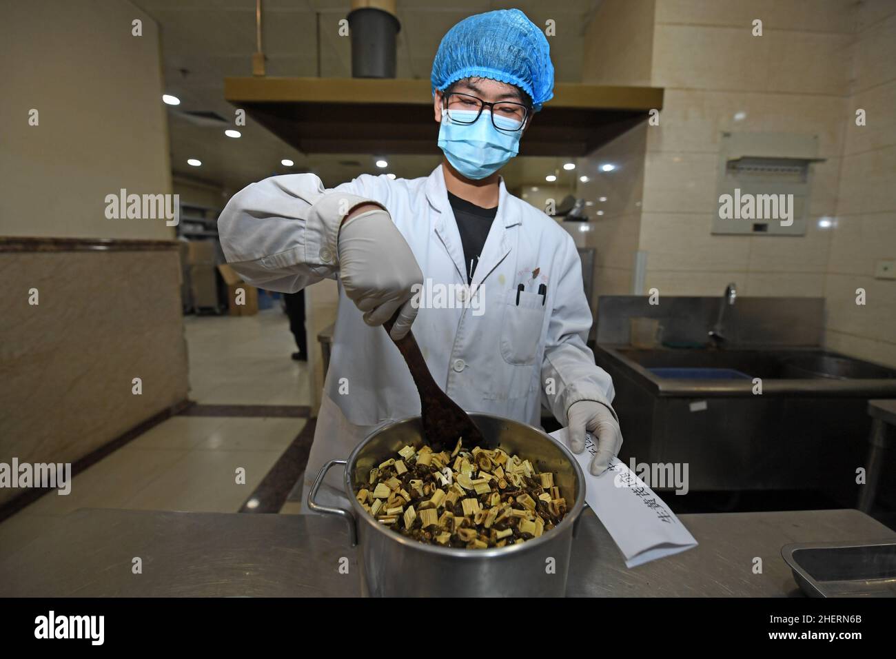Tianjin. 12th Jan, 2022. A pharmacist prepares ingredients to produce ...