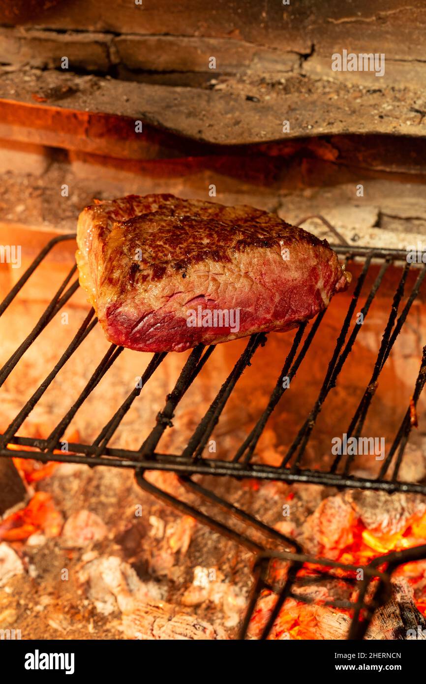 Tasty beef steak with blood on a charcoal grill. Delicious medium rare ...