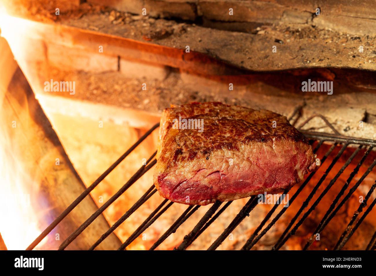 Beautiful piece of beef fillet on a coal grill. Tasty beef steak on ...