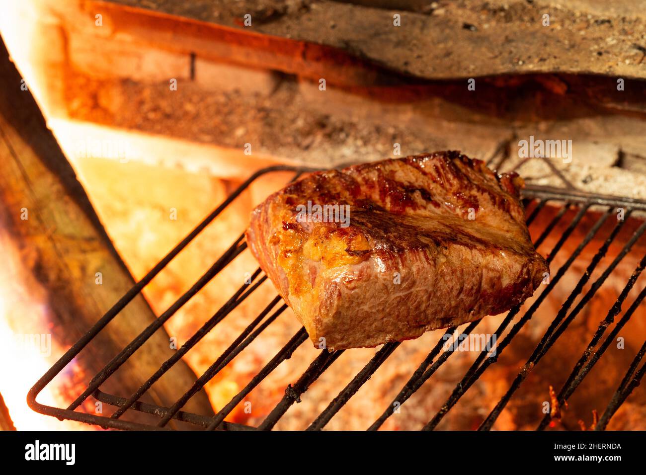 Tasty beef fillet steak on a grill. Fillet mignon roasting on hot coal ...