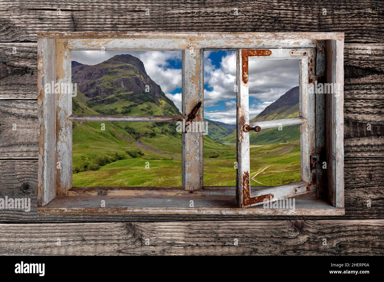 View through a rustic wooden window into the Glen Coe valley, Scottish ...
