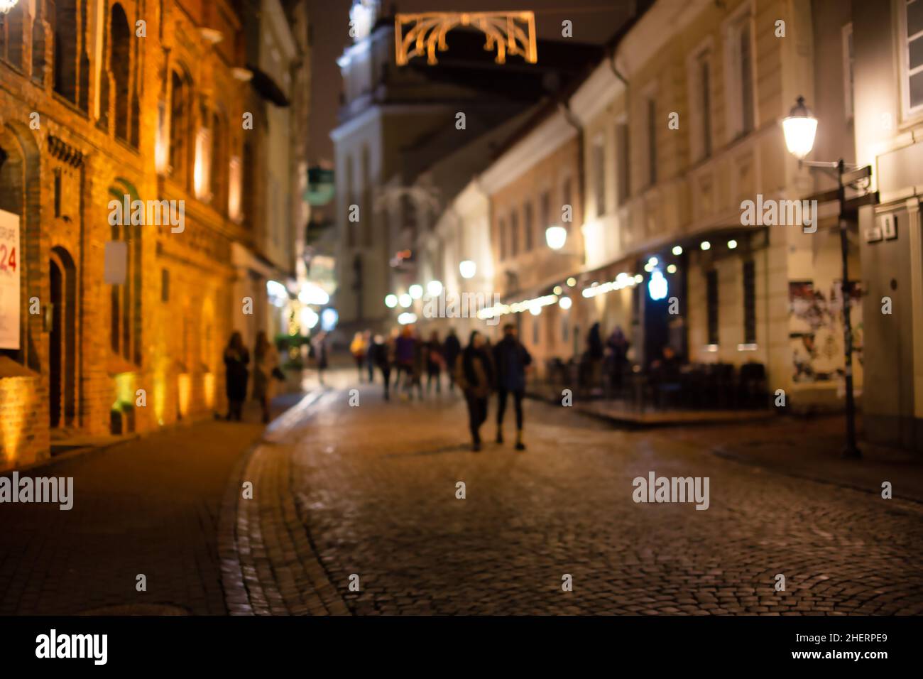 Pedestrianized street in the evening blurred background. People walking ...