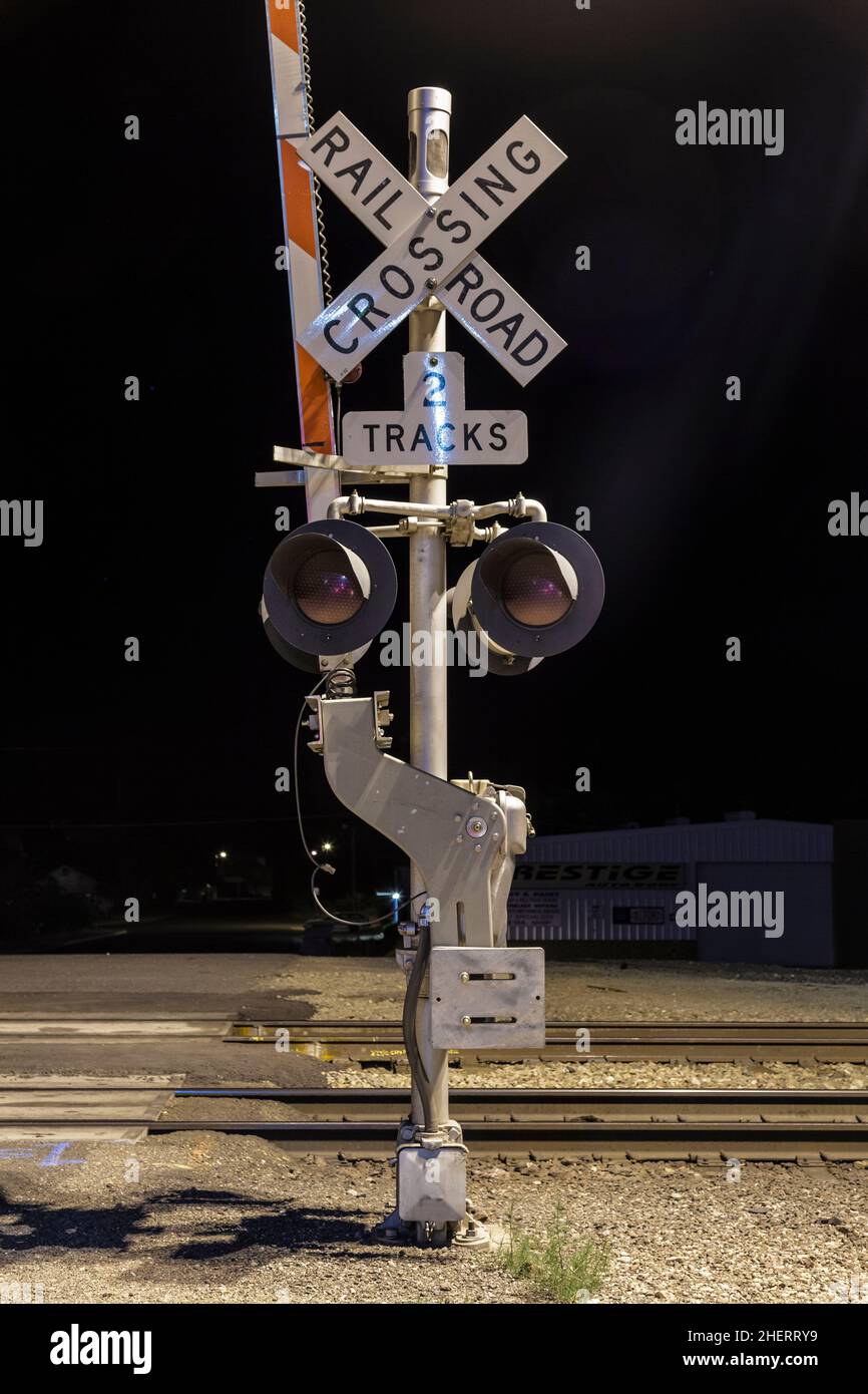 Railroad crossing by night with sign in kingman Stock Photo - Alamy