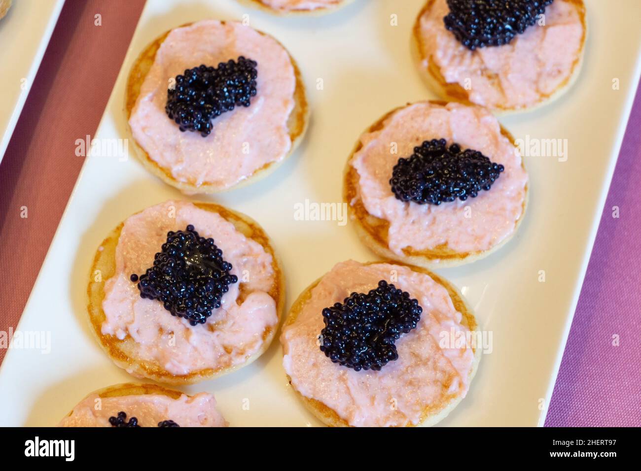 Blinis with taramasalata and lump-fish roe on a white plate Stock Photo ...
