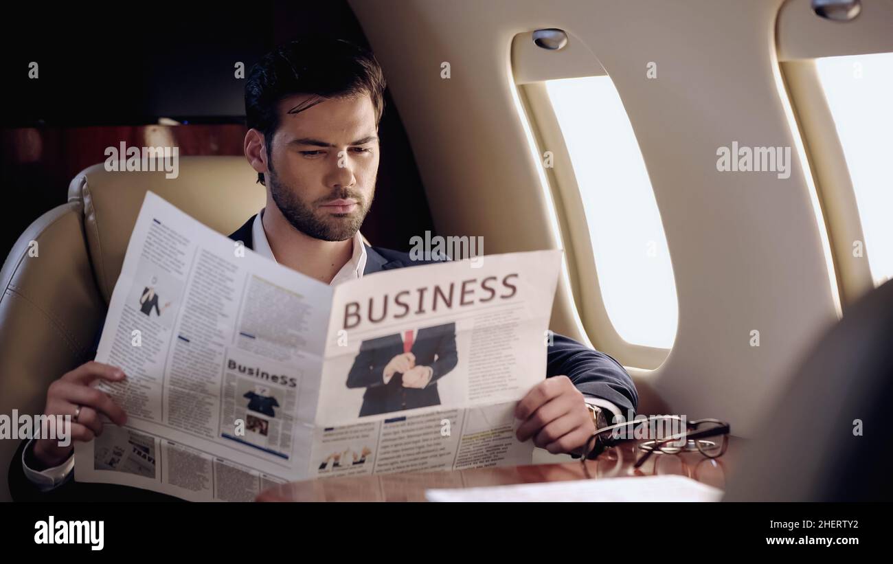 Reading newspaper in airplane hi-res stock photography and images - Alamy