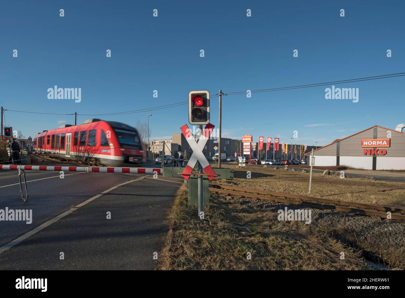 Passing train at a level crossing with barriers, Bavaria, Germany Stock ...