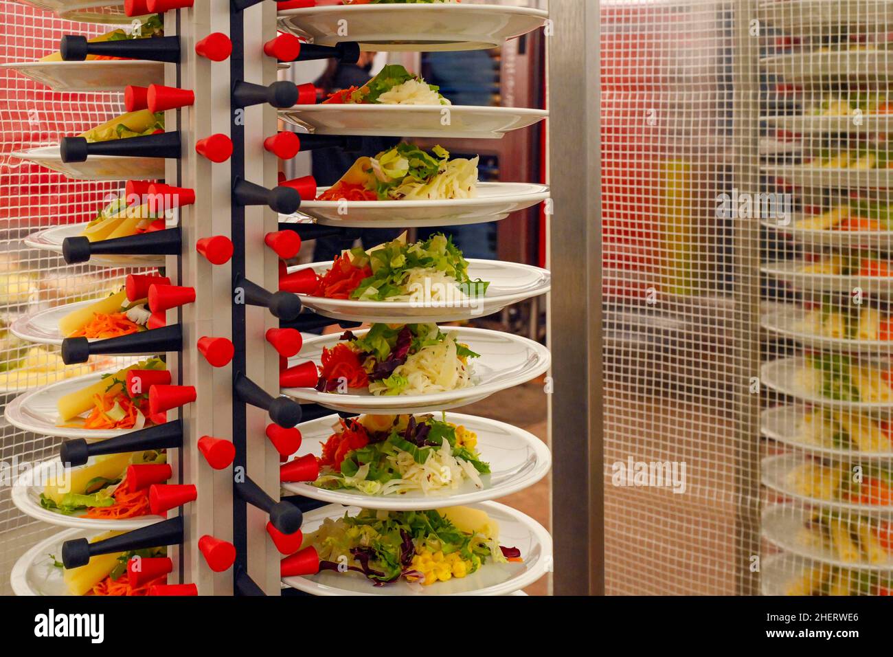 Stacked plates of mixed salad with sliced cheese and sprouts Stock ...