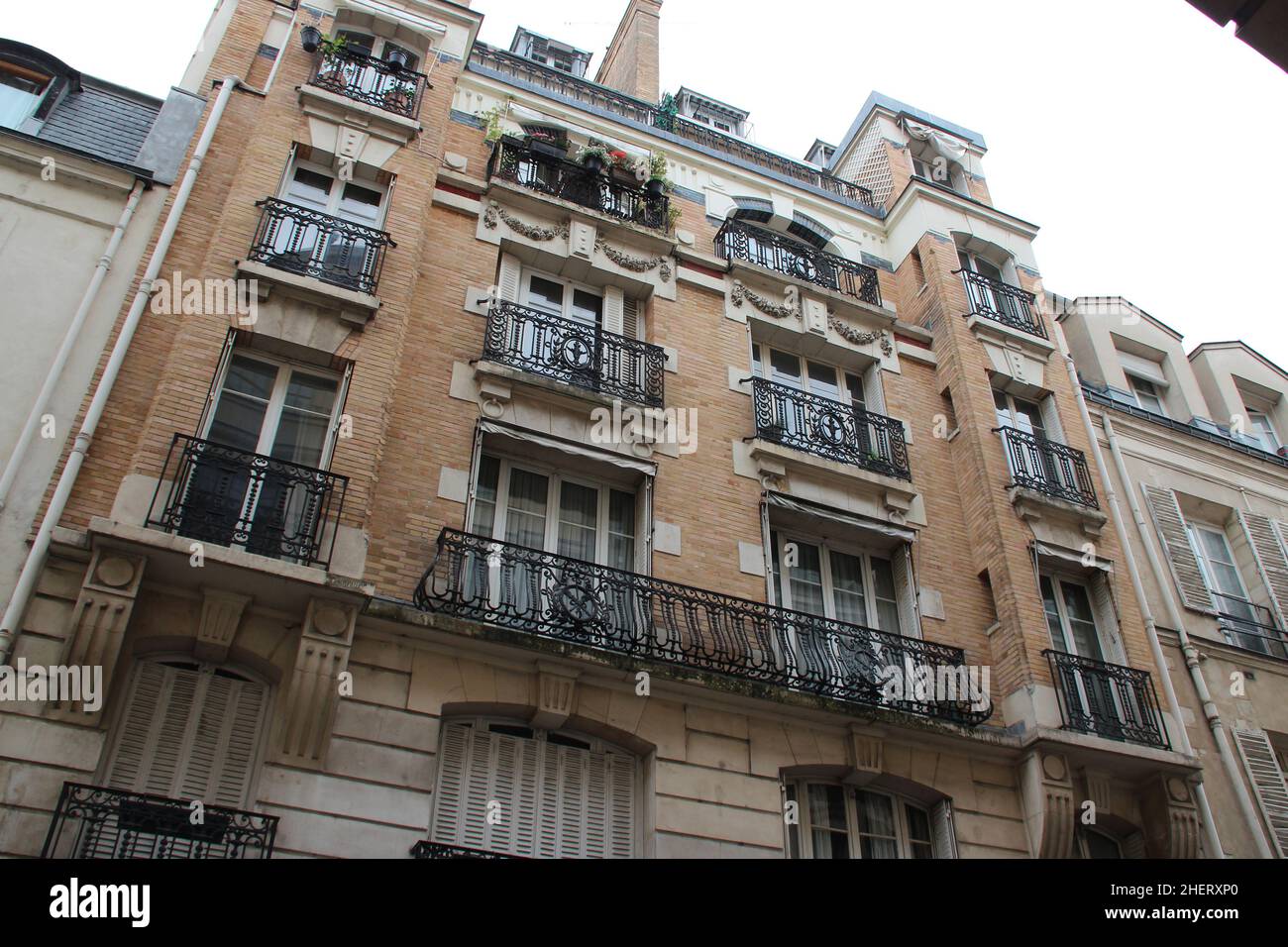 ancient brick flat building in paris in france Stock Photo - Alamy