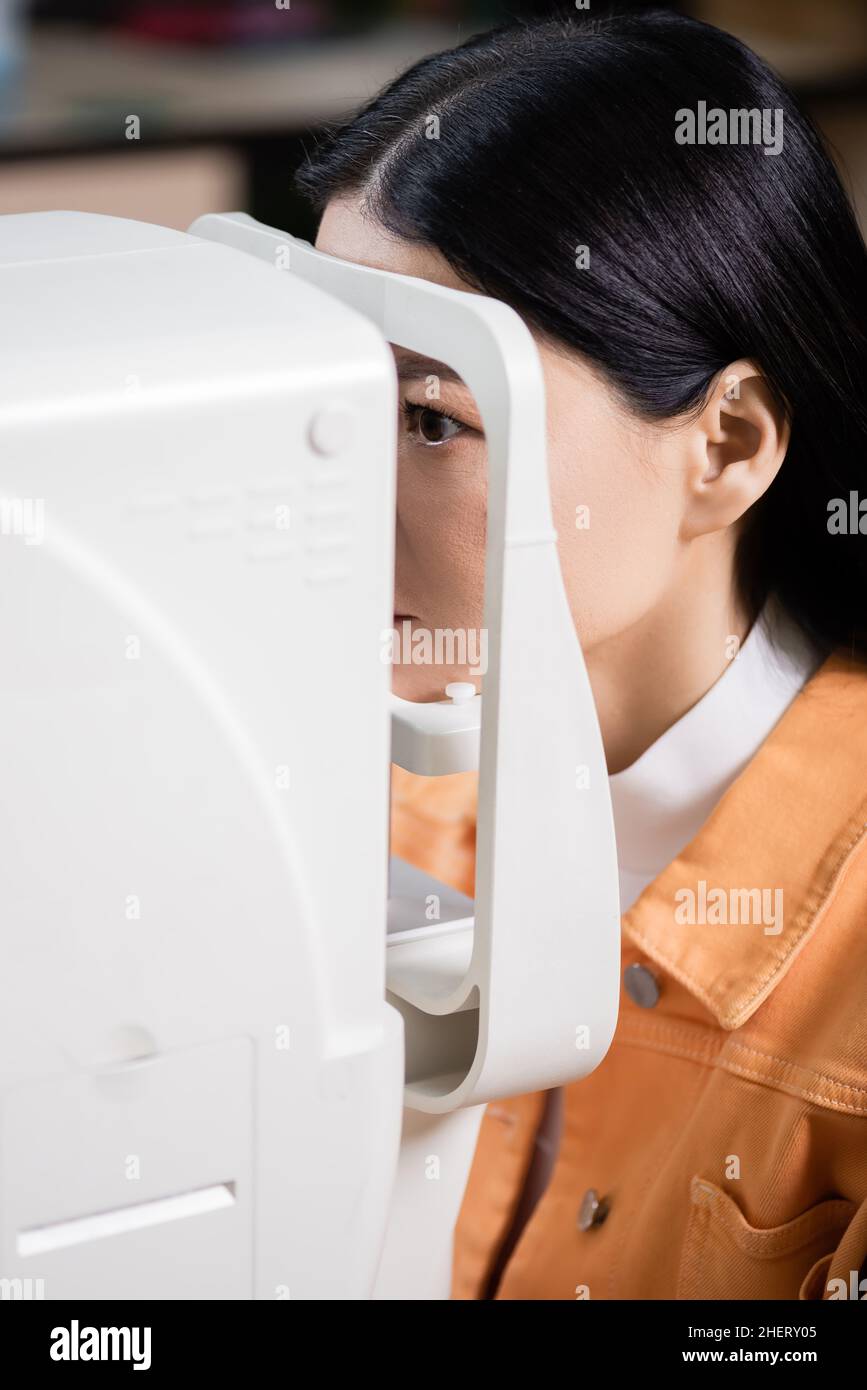 asian woman examining eyesight on blurred ophthalmoscope Stock Photo ...