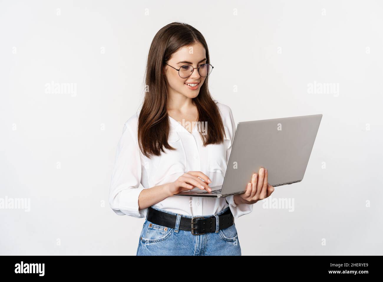 Portrait of young office woman, entrepreneur answer clients on laptop ...