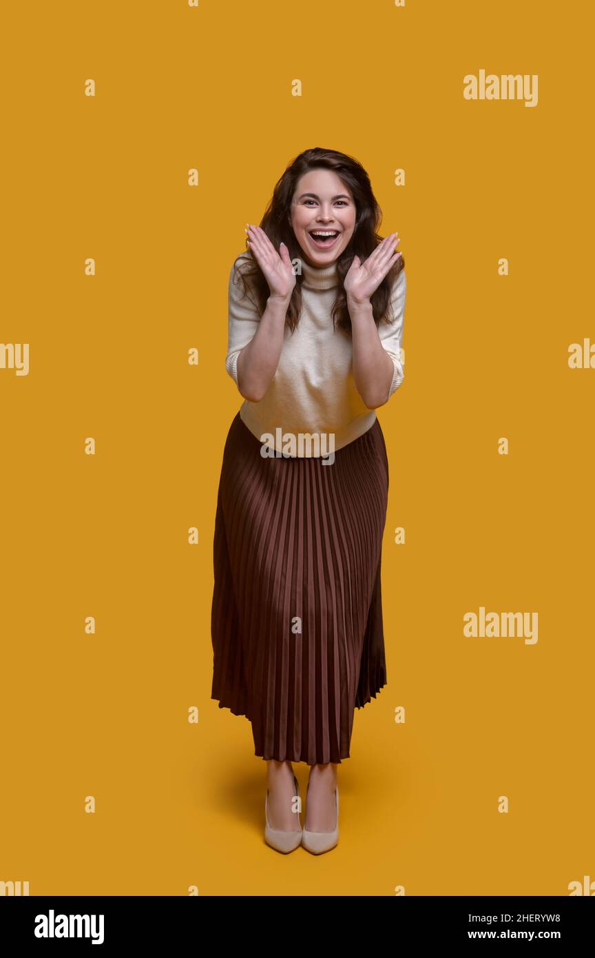 Cheerful cute lady leaning forward with open palms Stock Photo - Alamy