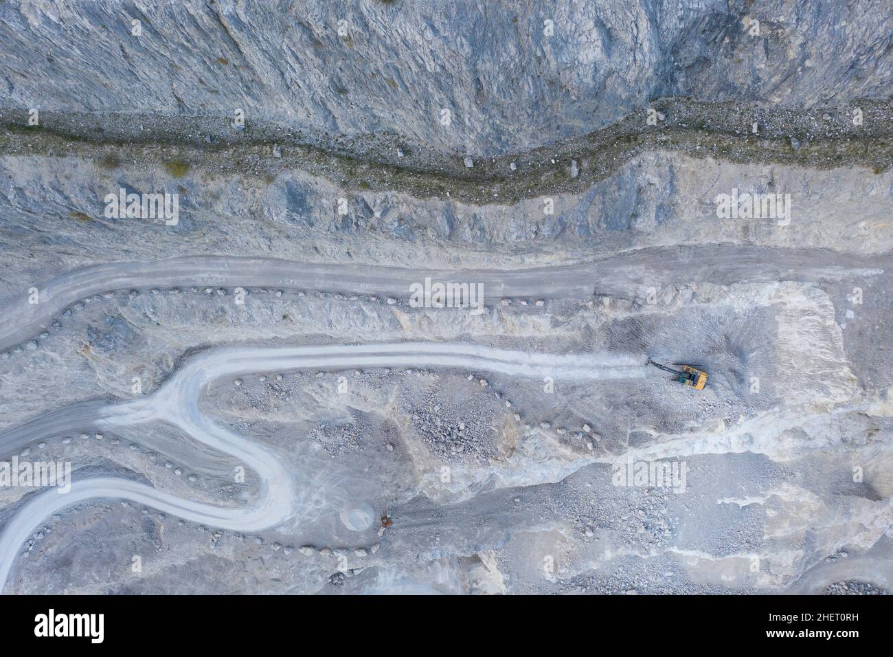 bird's eye view to stone pit quarry with shovel excavator tracks and ...
