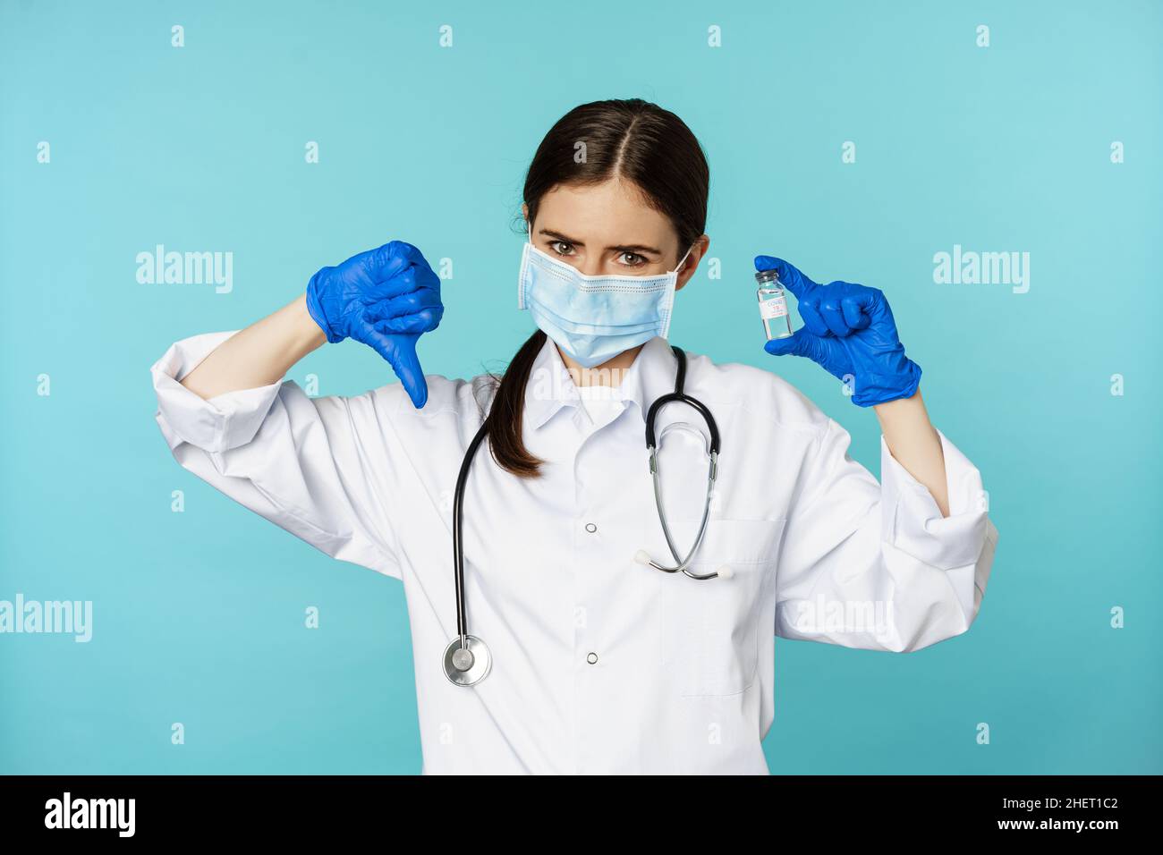 Sad and disappointed young doctor, woman showing vaccine and dislike ...