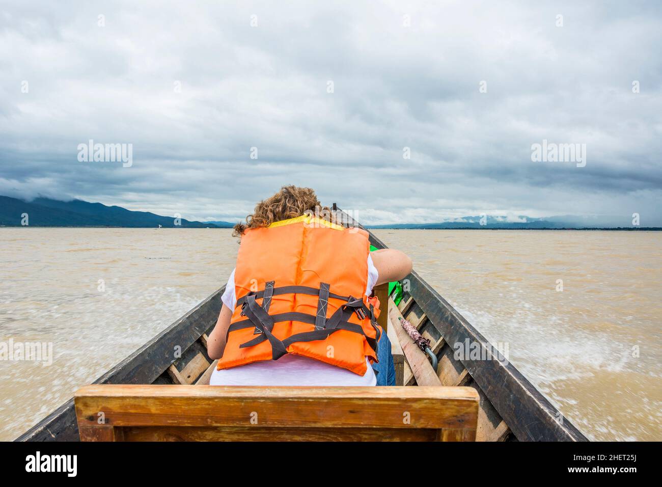 female tourist in water taxi at Inle lake in cloudy weather Stock Photo ...