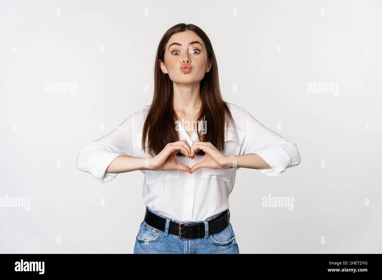 Lovely feminine woman showing heart sign, romantic gesture and smiling ...