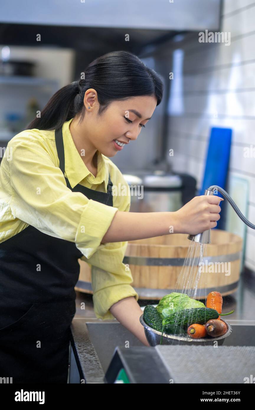 Woman in the kitchen washing vegetables before cooking Stock Photo - Alamy