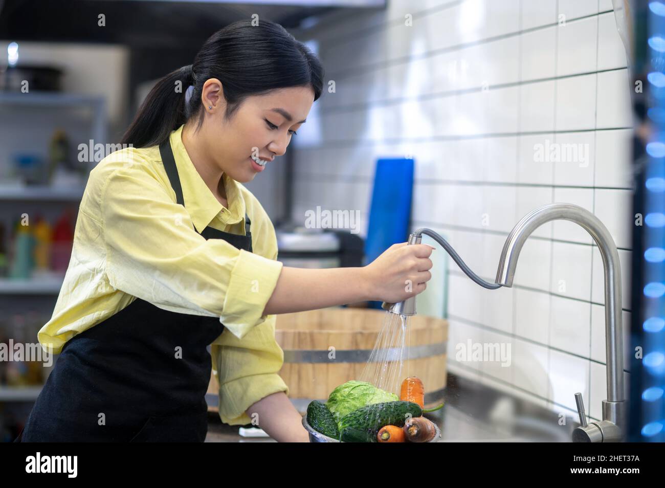 Woman in the kitchen washing vegetables before cooking Stock Photo - Alamy