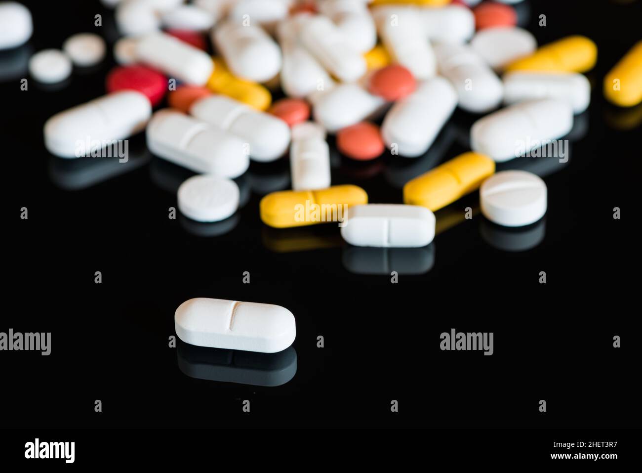 perspective view to drug pills on black background Stock Photo - Alamy