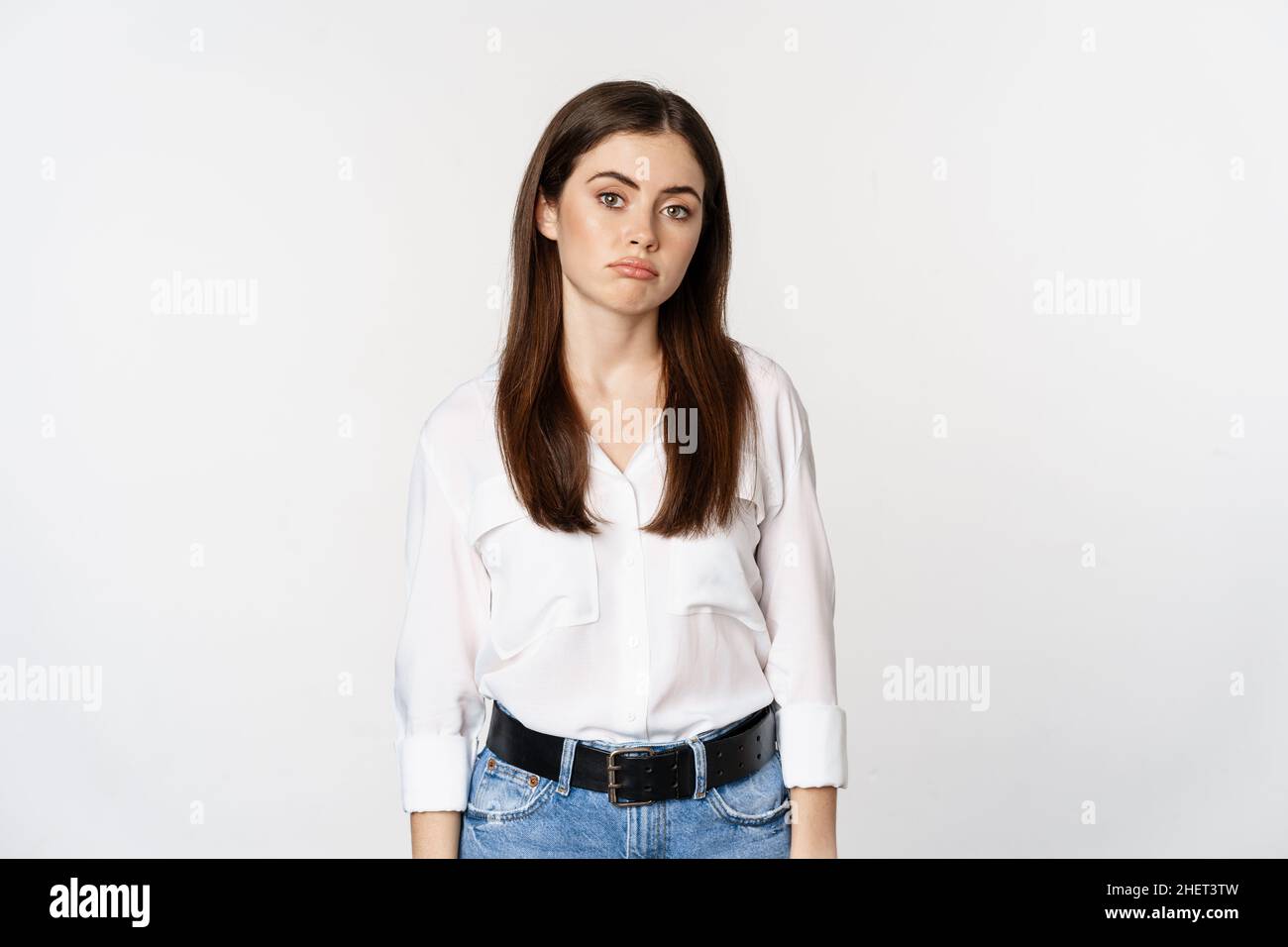 Sad and gloomy woman sulking, looking disappointed and moody, standing ...
