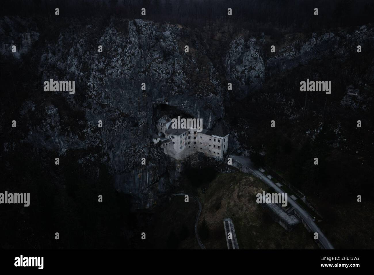 Aerial of Haunted mystic predjama castle built into a mountain by ...