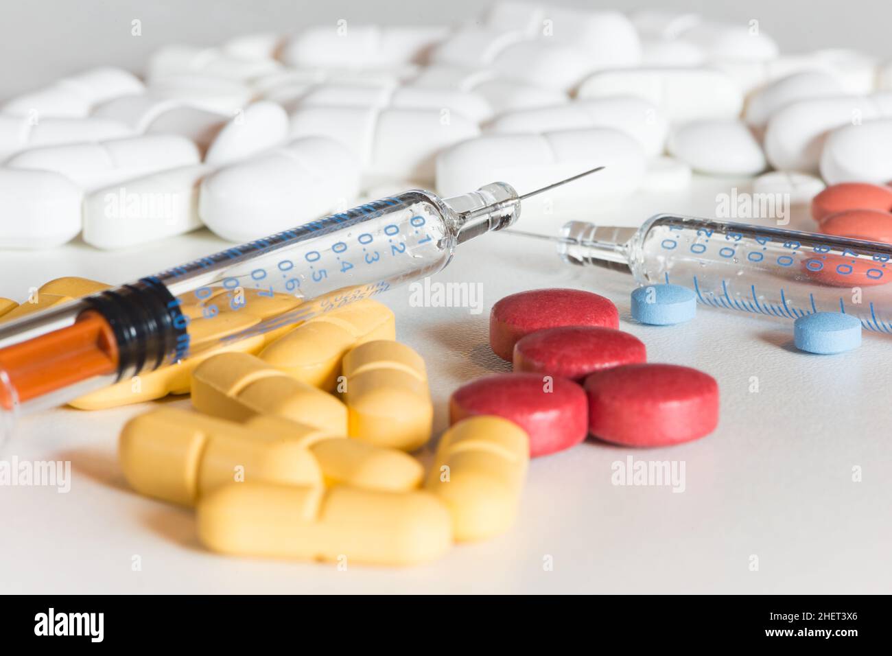 medical colored pills and injection on white background Stock Photo - Alamy
