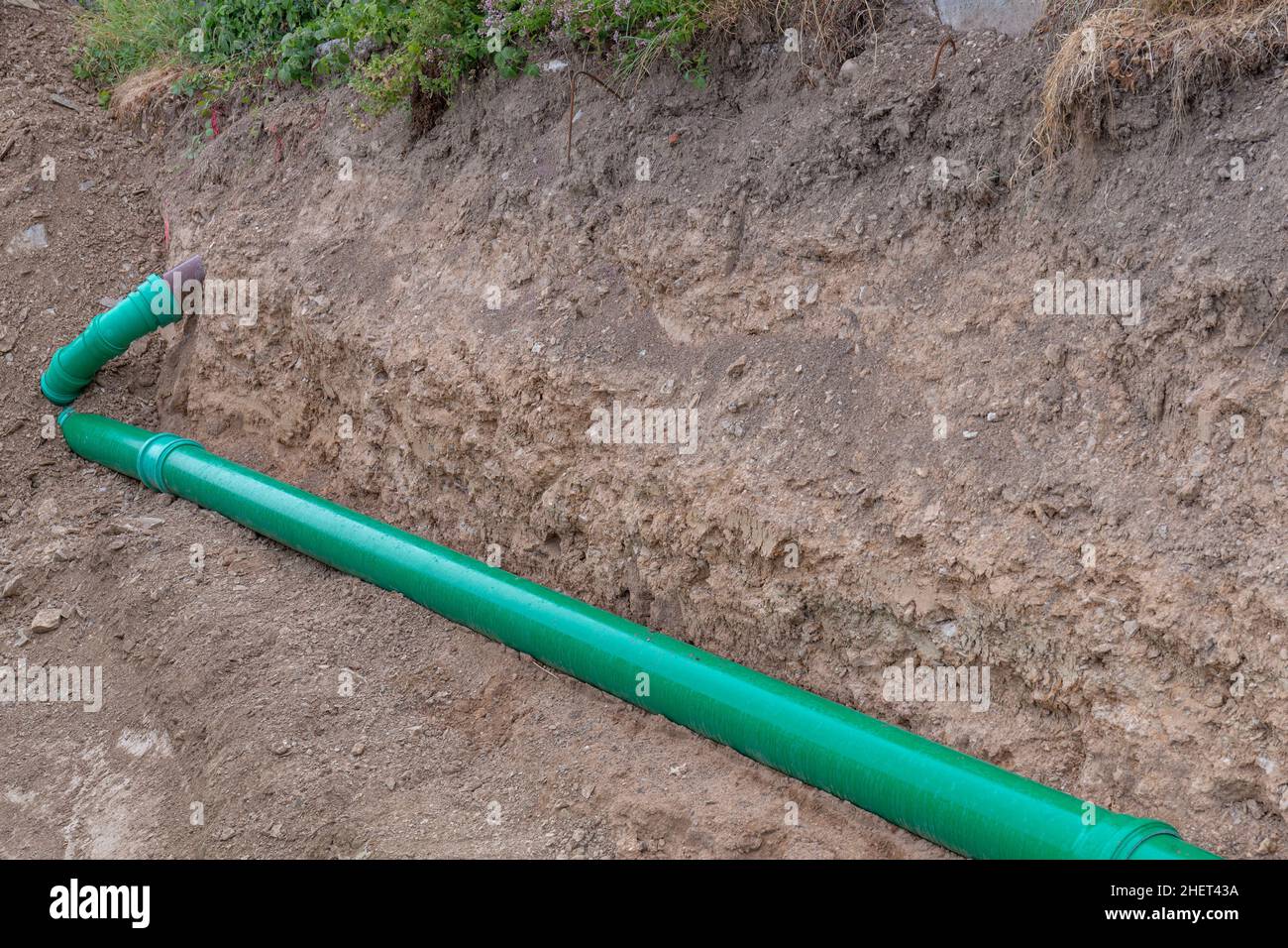 green pipe under earth at a construction site Stock Photo - Alamy