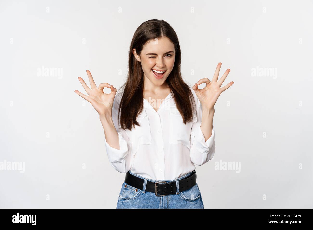 Smiling confident business woman, winking, showing okay ok sign ...