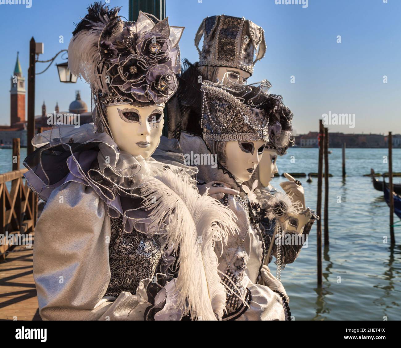 People in beautiful fancy dress historic costume and mask by the lagoon ...