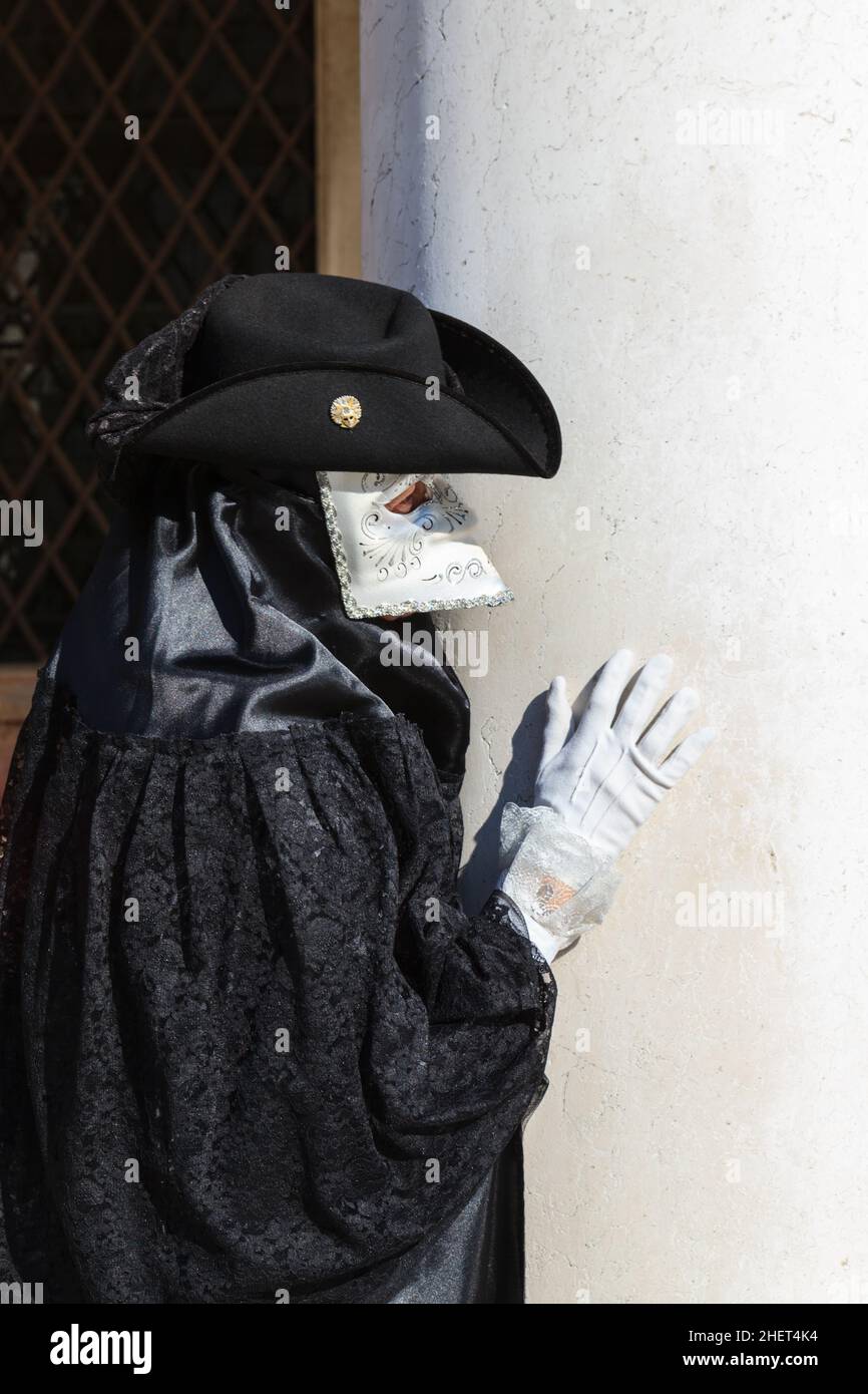 Man in historic bauta costume with tricorn black hat, tabarro mantle ...