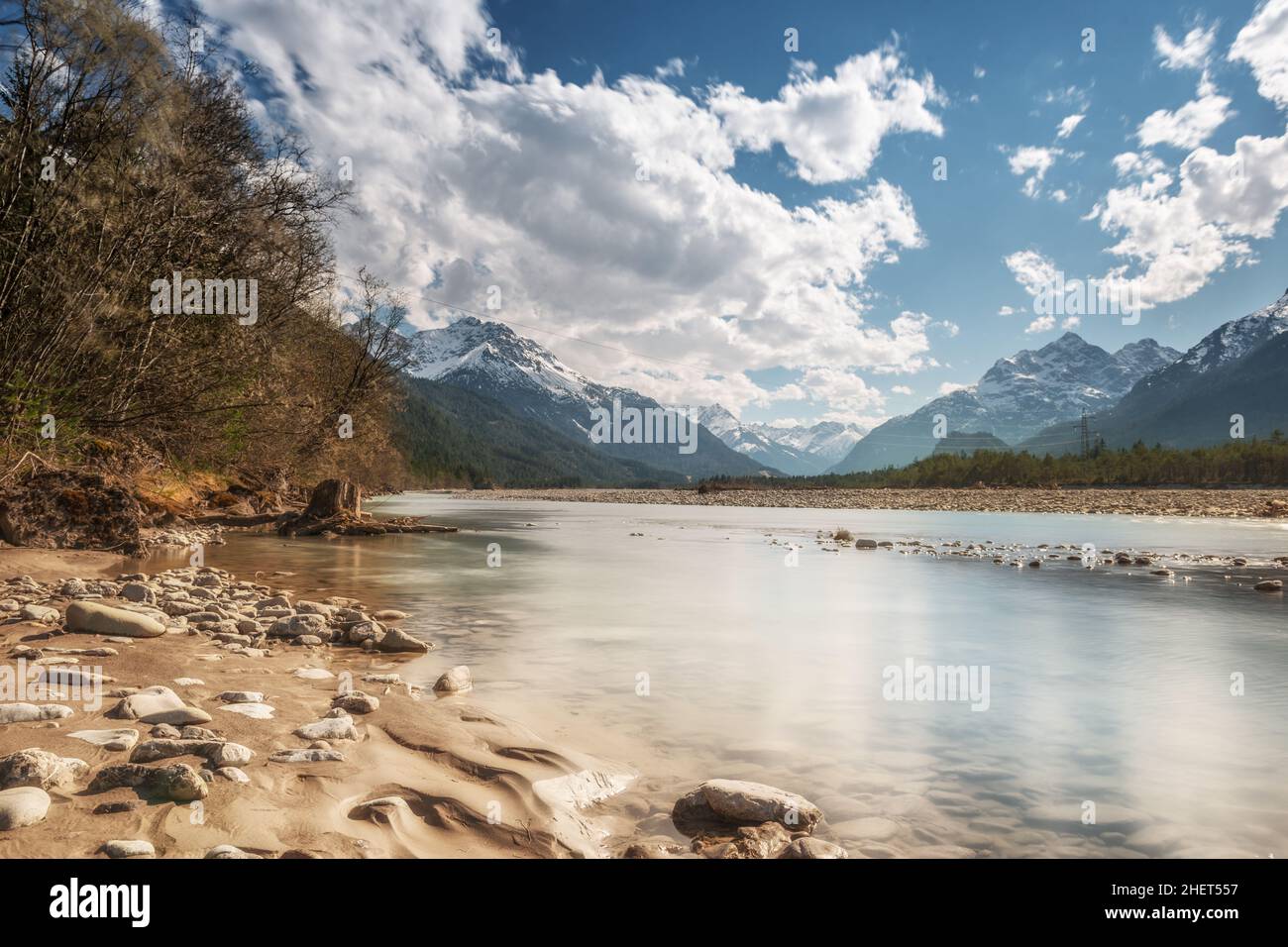 sandy and stony river bank with cold water in austrian mountain valley ...