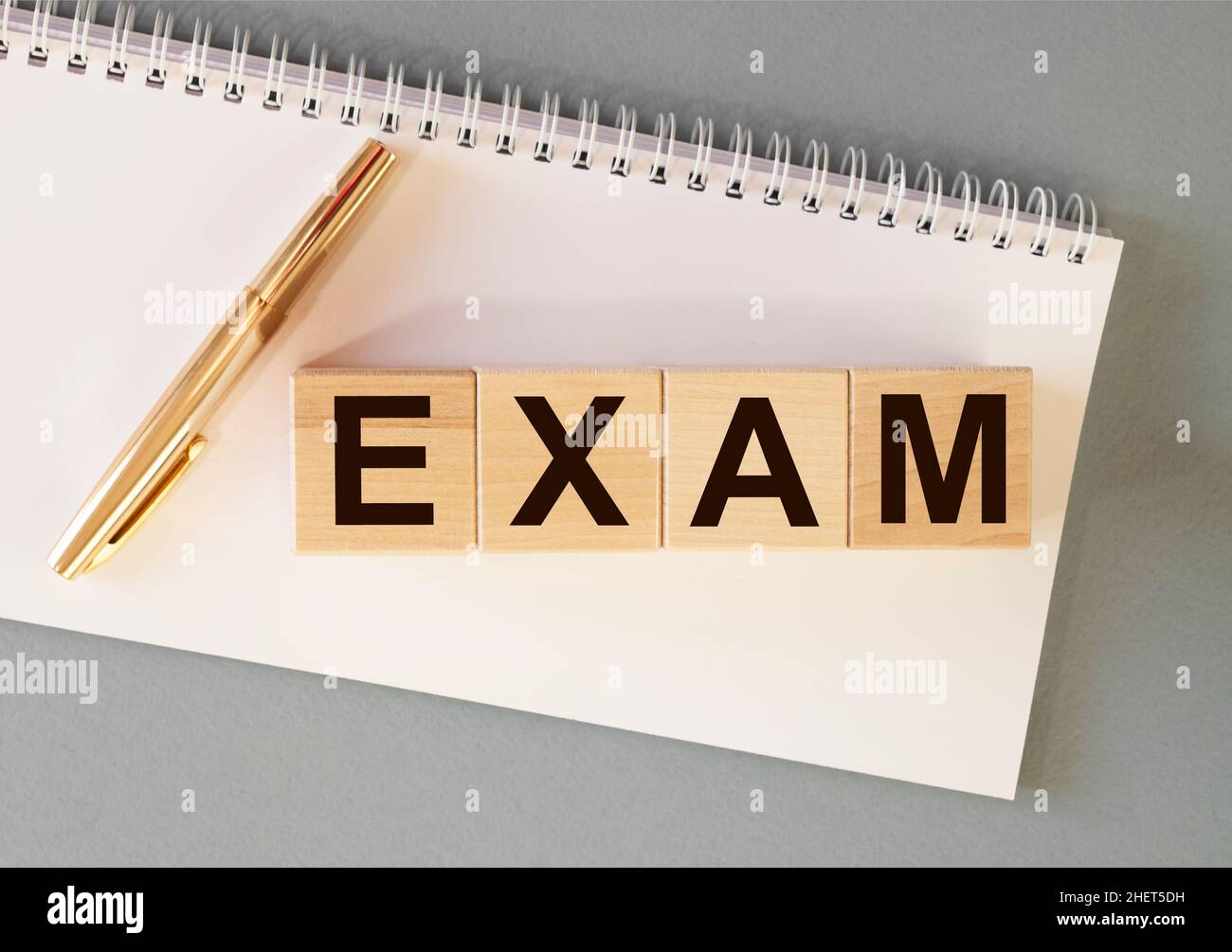 Exam word. Examination concept on wood cubes and notepad Stock Photo ...