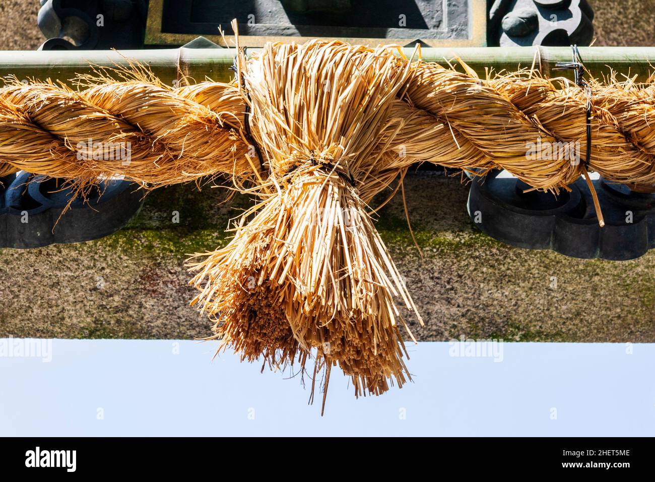 A Japanese Shimenawa, twisted sacred rope, made from straw, hanging ...