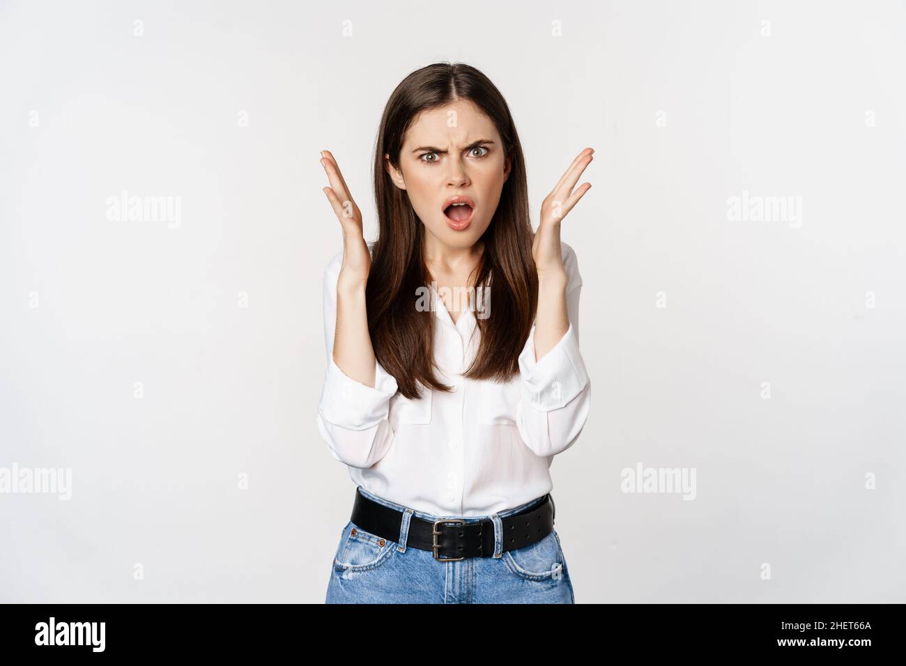 Frustrated and angry young woman gasping, looking shocked and upset at ...