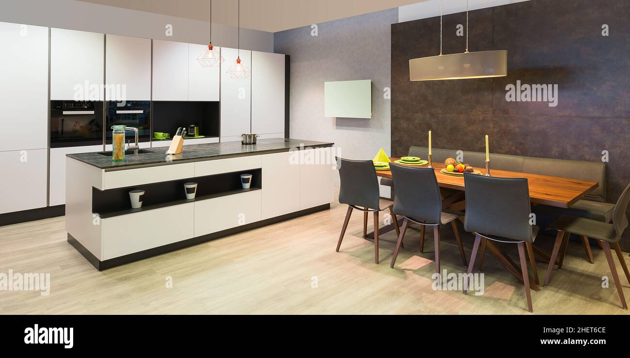 modern flat white kitchen with elegant wooden dinette Stock Photo - Alamy