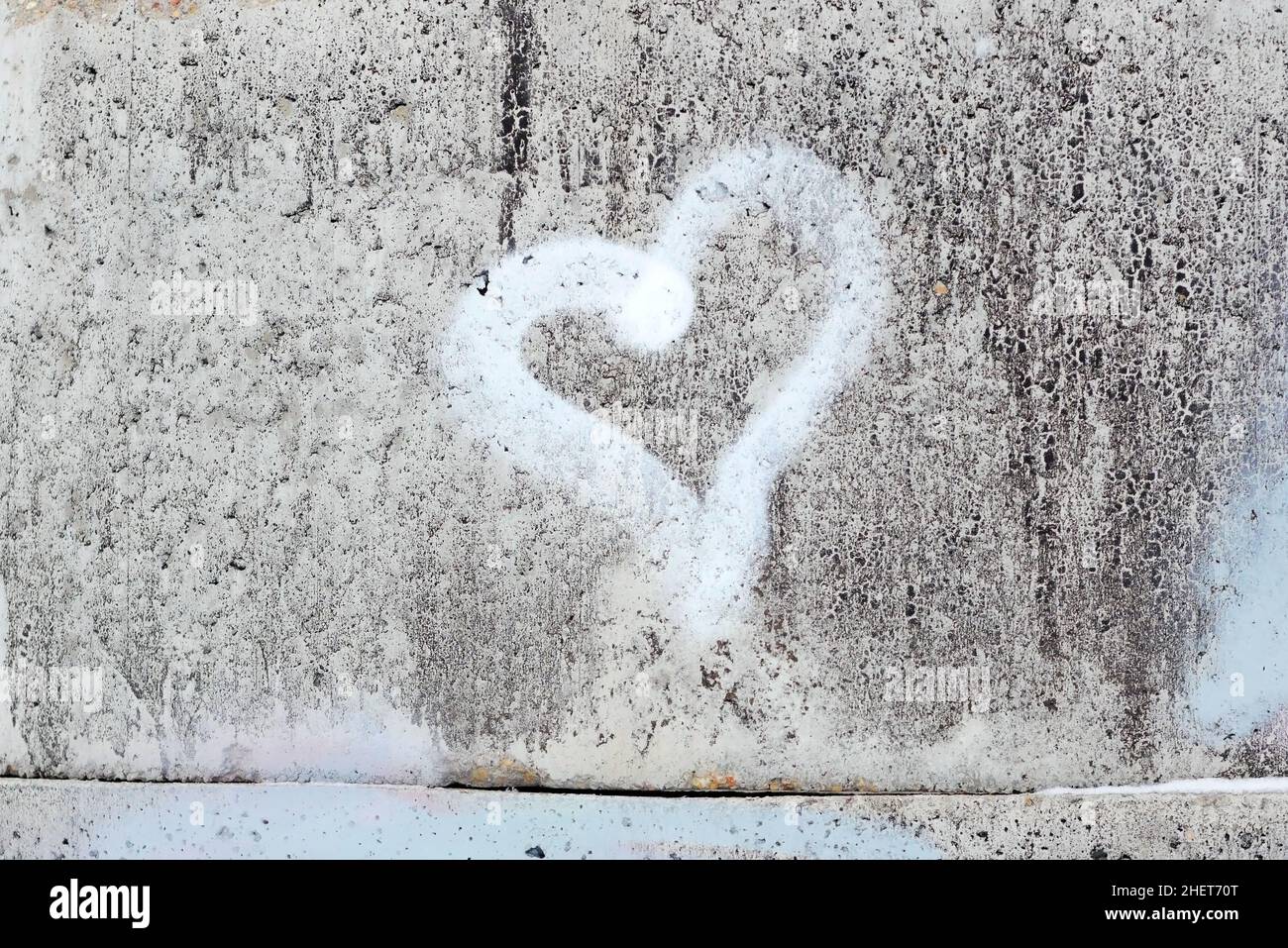 Heart on the concrete wall with white paint close-up. Confession of ...