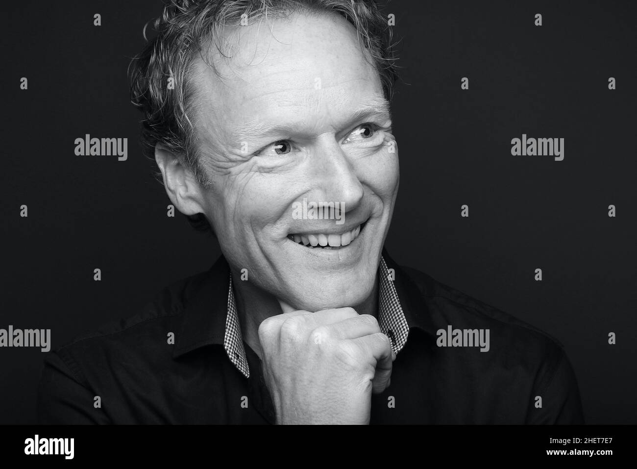 Portrait of a beautiful happy man in front of a colored background ...