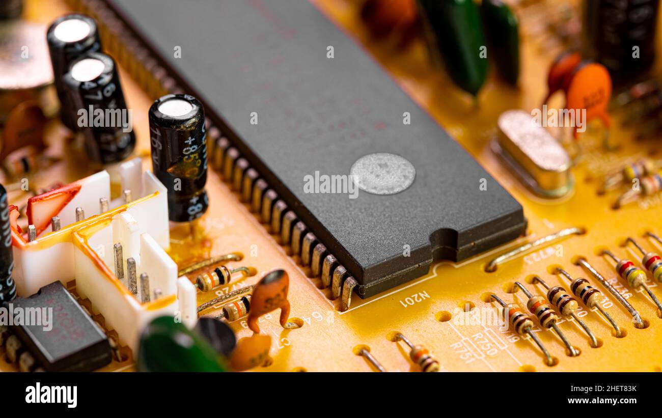 Macro Close up of components and microchips on old PC circuit board ...