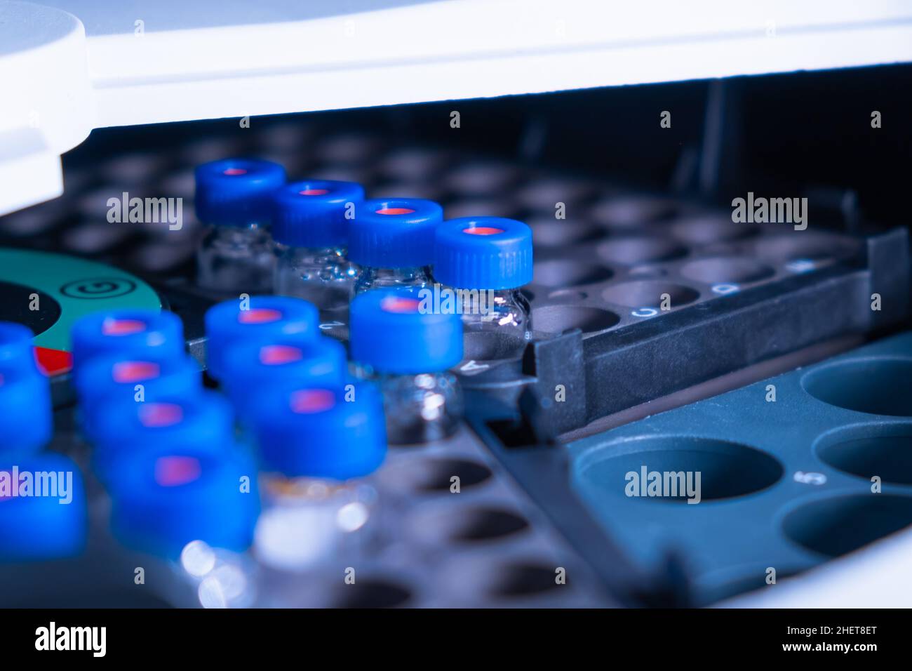 Close up vials with blue caps in the rack of auto sample for LC MS ...