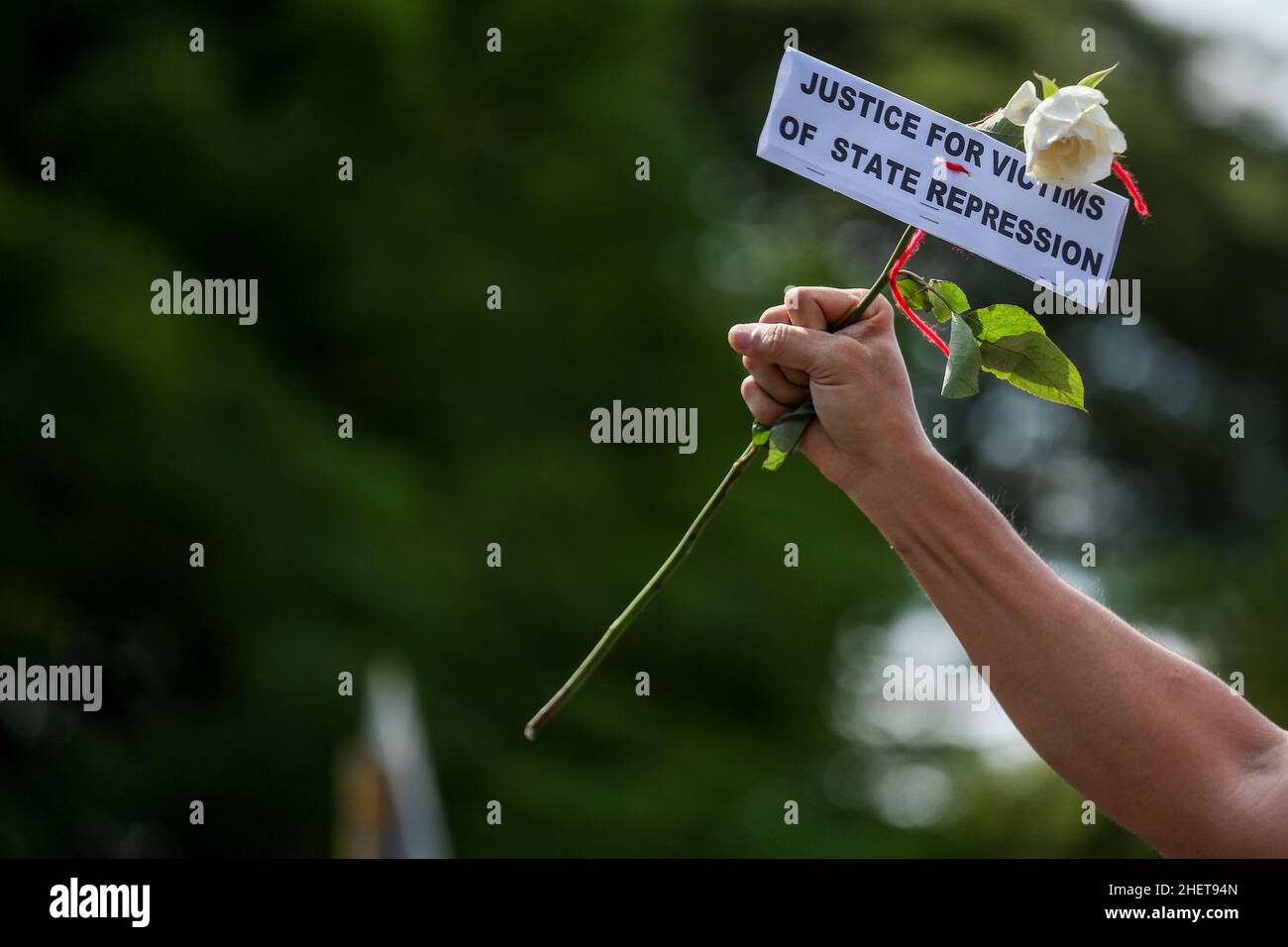 Manila, Philippines. 10th Dec, 2021. An activist holds a flower with a ...