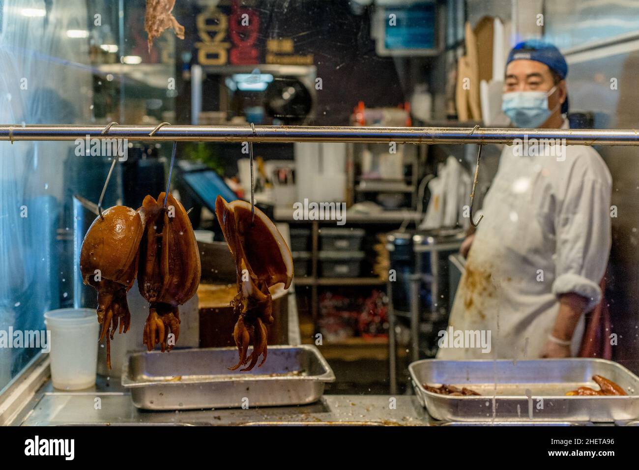 Cook wears mask while preparing food in Chinese restaurant in Chinatown ...