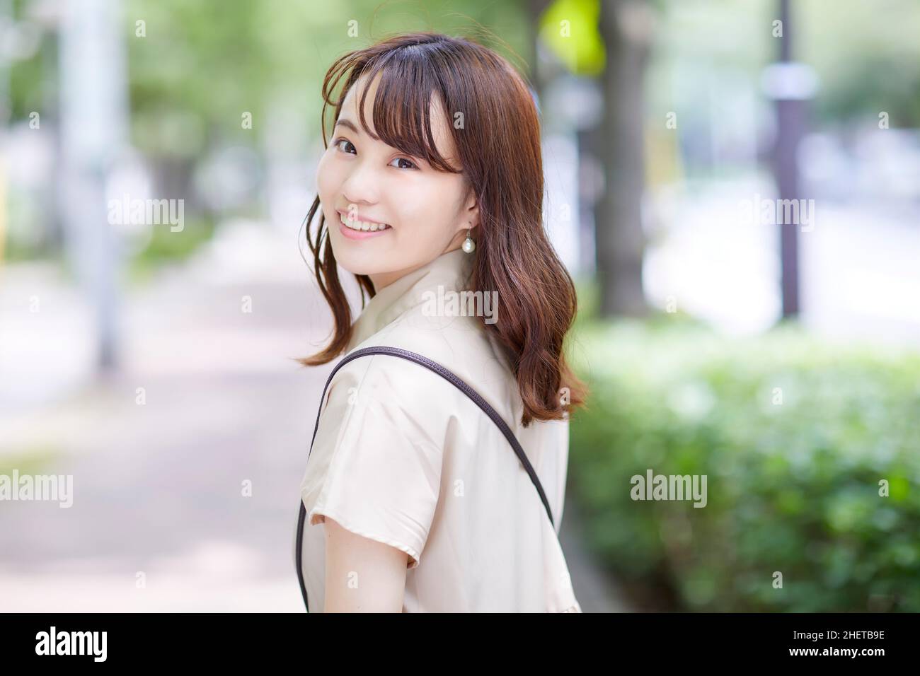 Japanese Woman Looking Back With Smile Stock Photo - Alamy